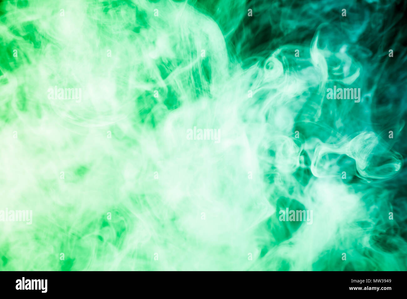 Thick colorful green smoke on a black isolated background. Background ...