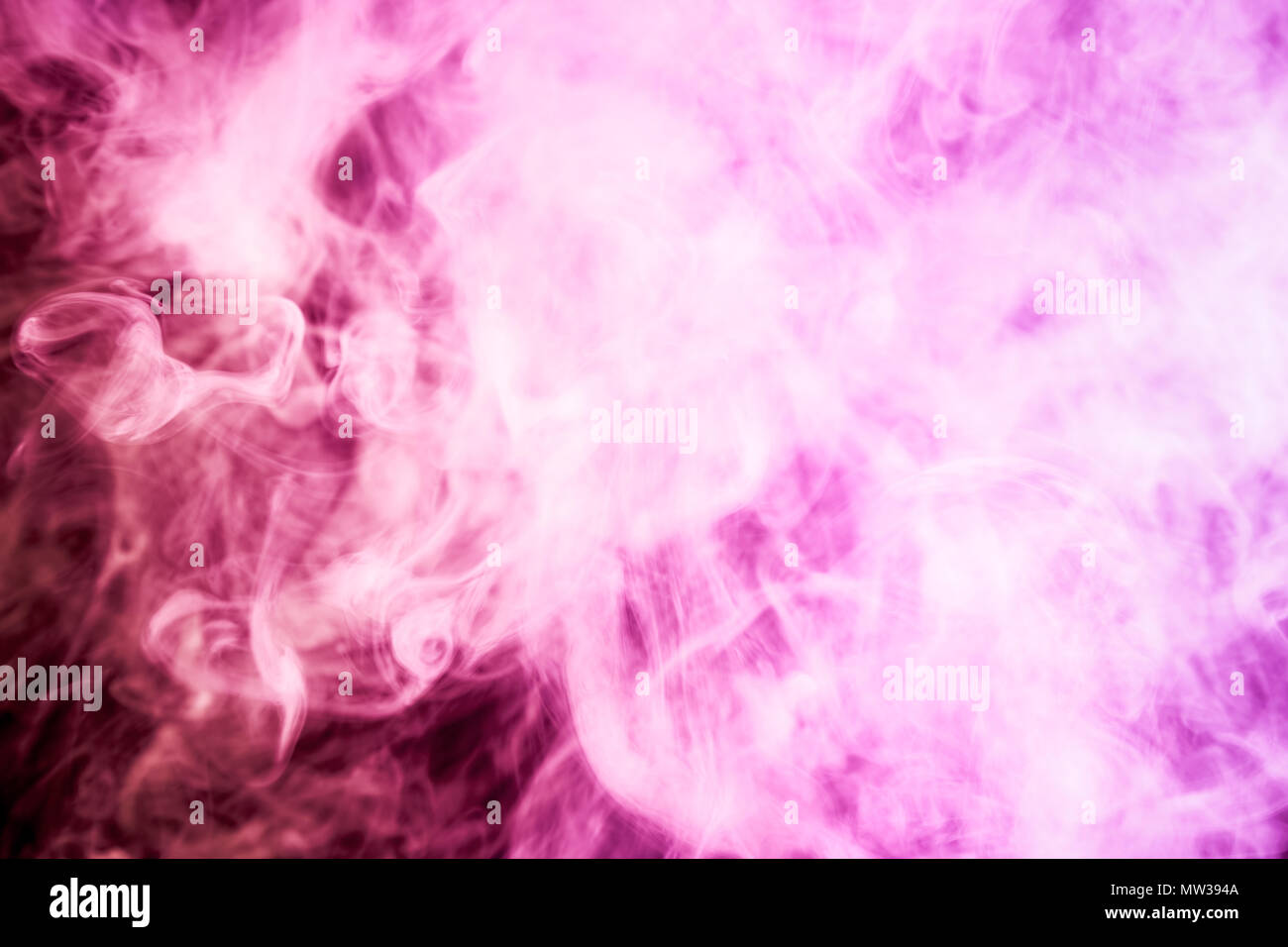 Thick colorful pink smoke on a black isolated background. Background ...