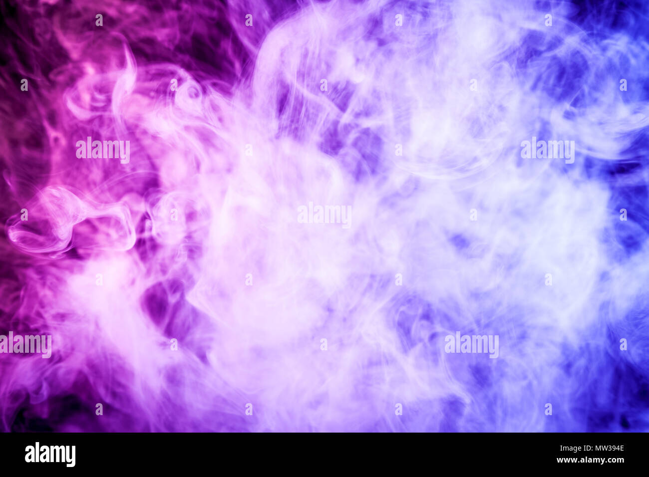 Thick colorful purple smoke on a black isolated background. Background ...