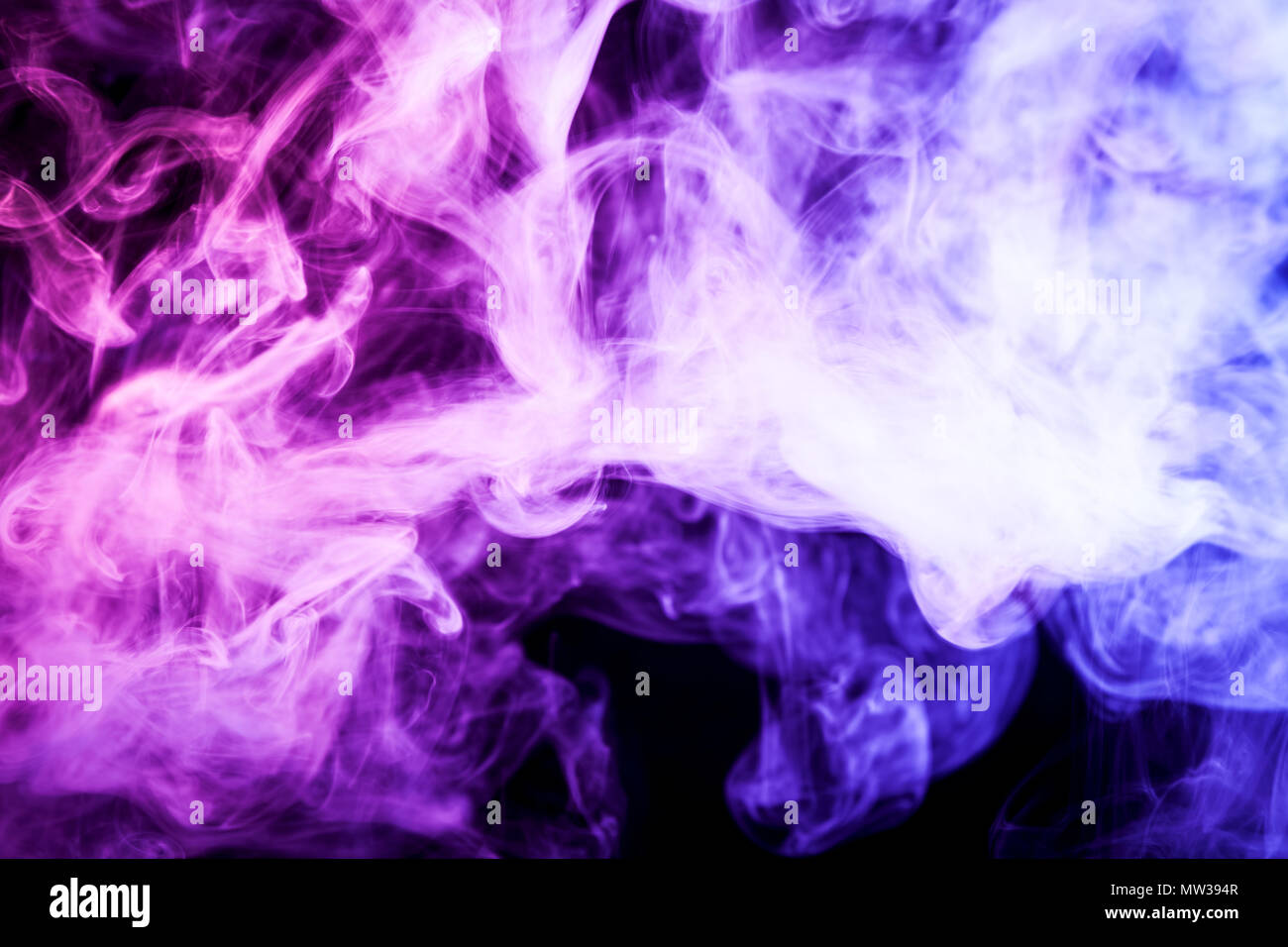 Colorful purple smoke on a black isolated background. Background from ...