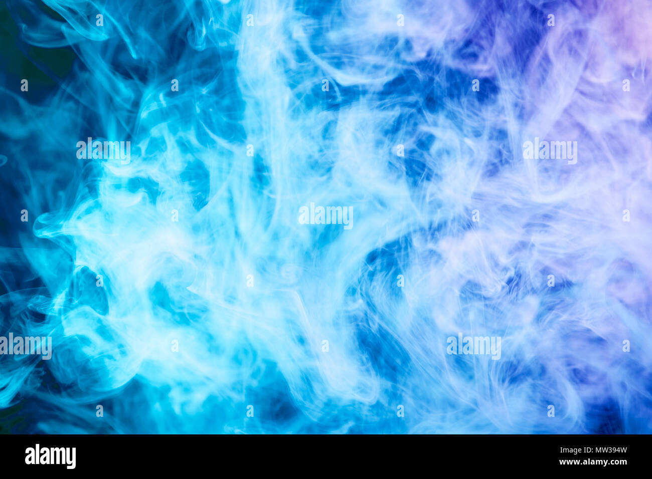 Colorful blue smoke on a black isolated background. Background from the ...