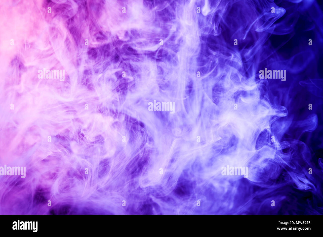 Colorful purple smoke on a black isolated background. Background from ...