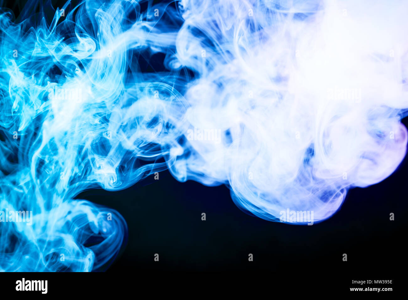 Colorful blue smoke on a black isolated background. Background from the ...