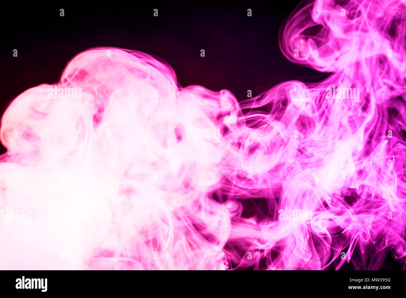 Colorful pink smoke on a black isolated background. Background from the ...