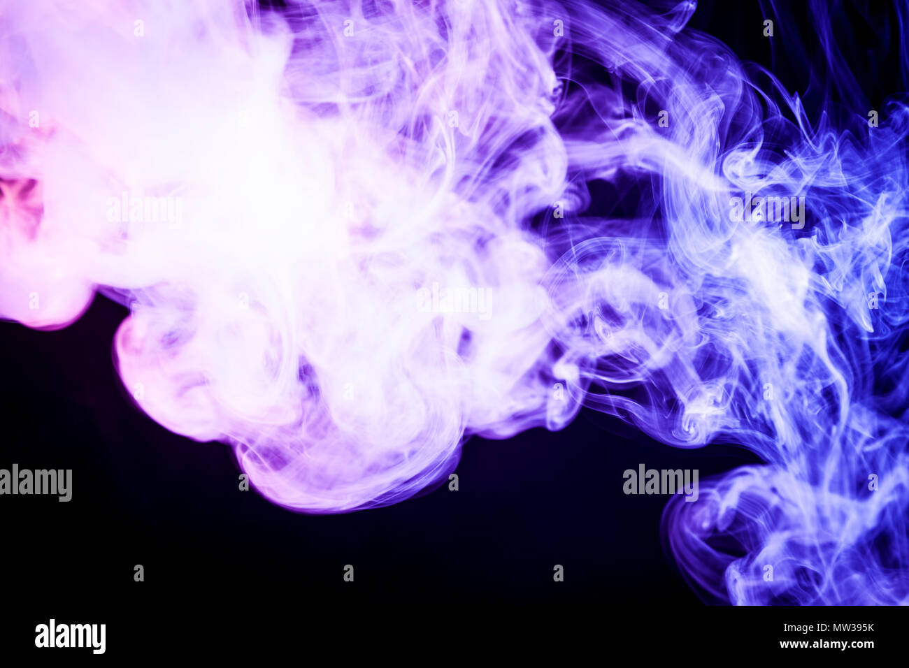 Colorful purple smoke on a black isolated background. Background from ...