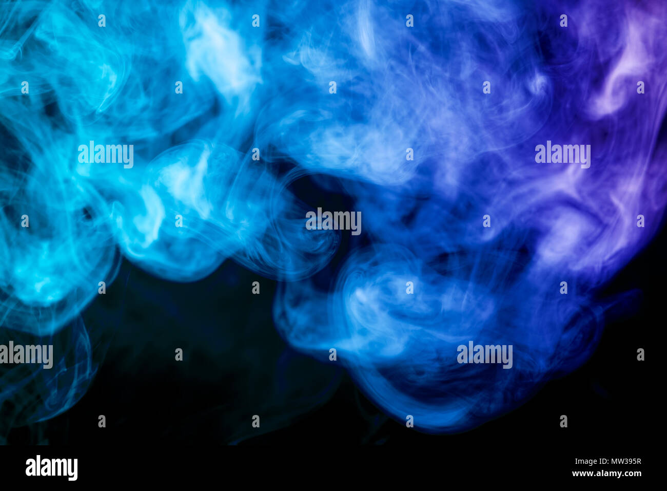 Colorful blue smoke on a black isolated background. Background from the ...