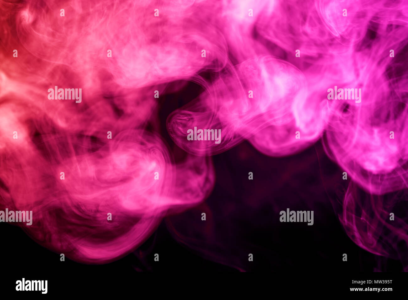Colorful pink smoke on a black isolated background. Background from the ...