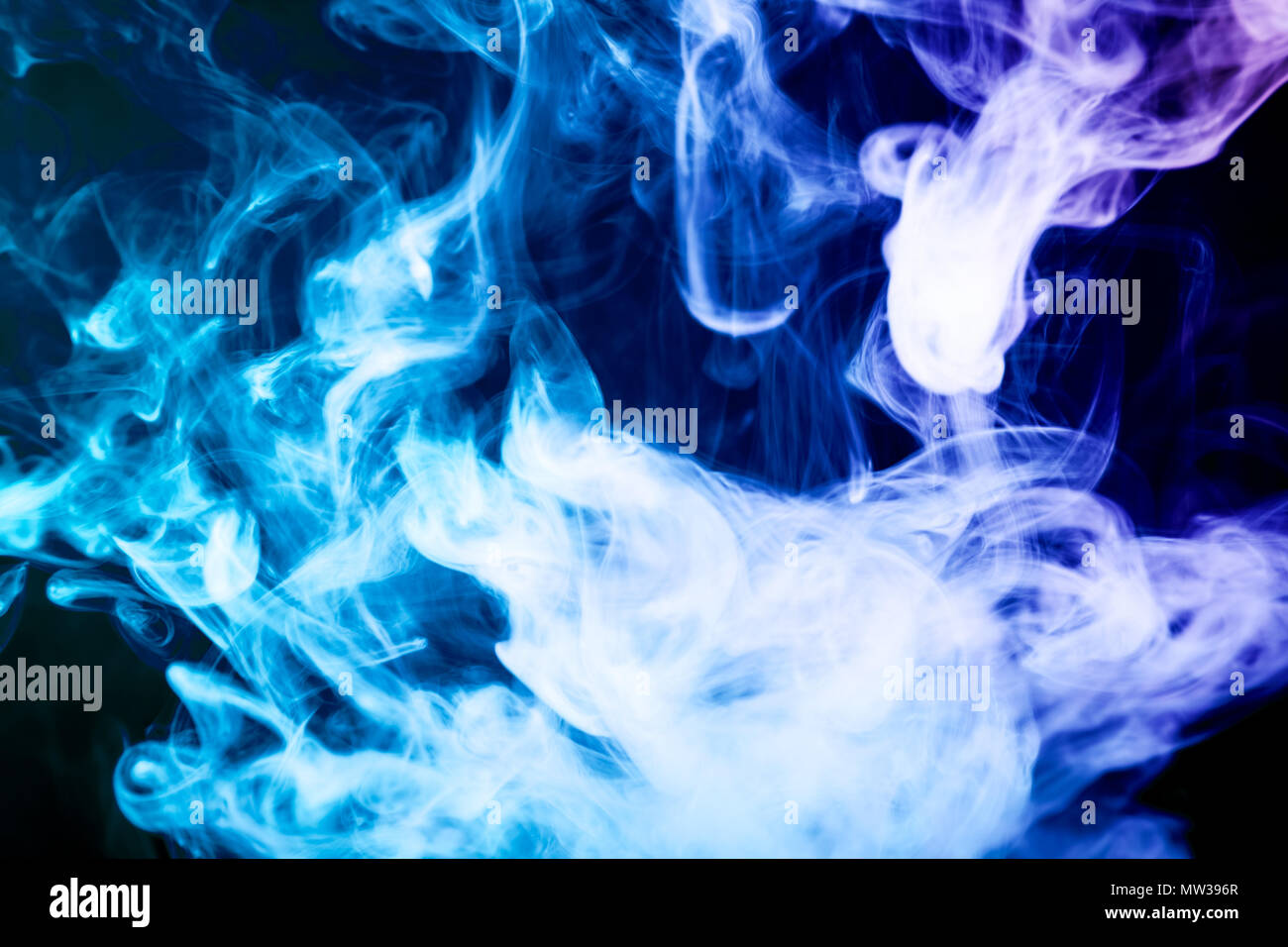 Colorful blue smoke on a black isolated background. Background from the ...