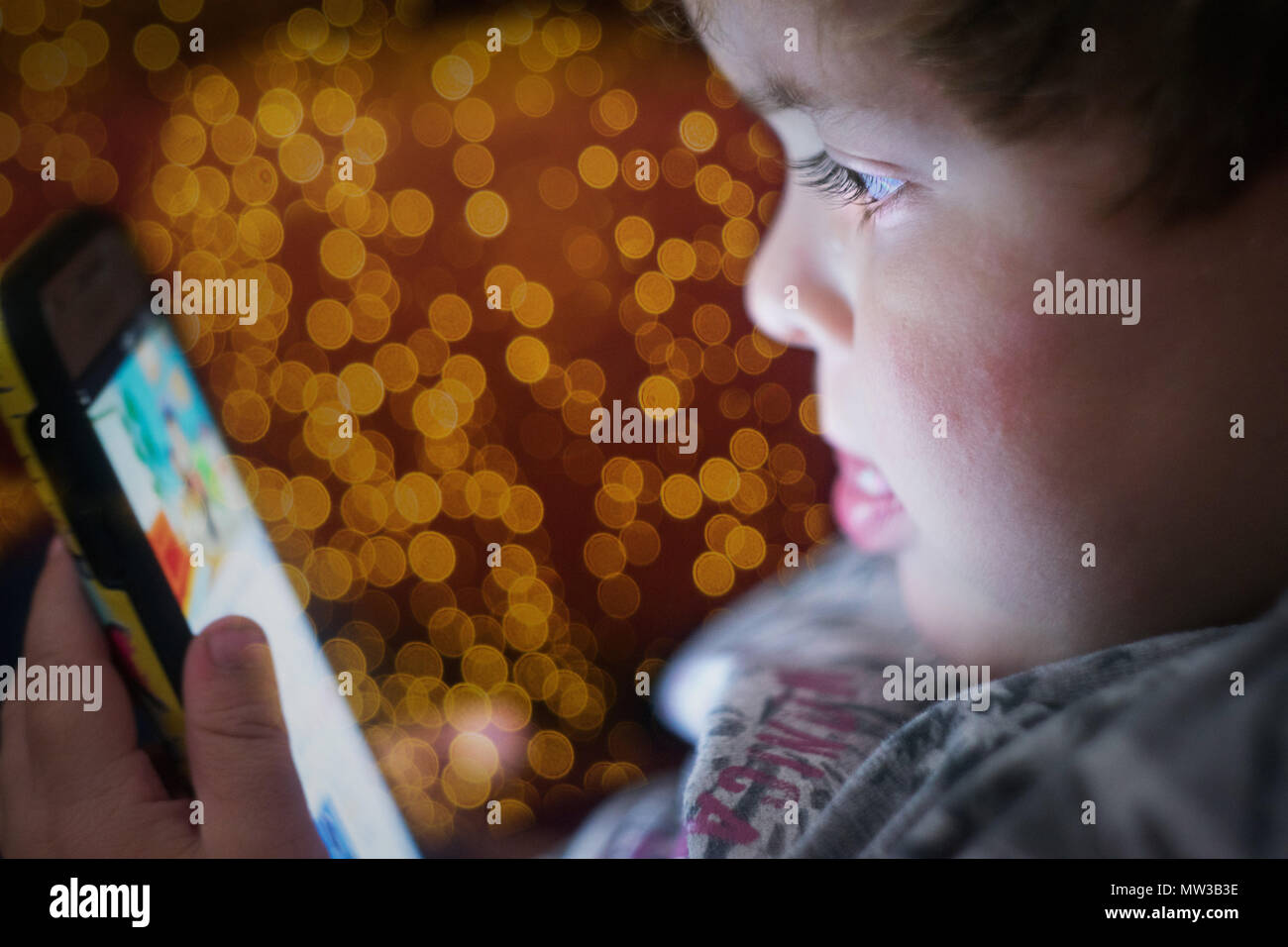 Little boy child kid playing games on smartphone mobile phone Stock ...