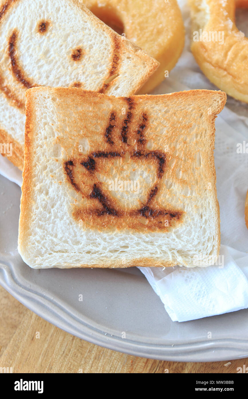 Coffee burn mark on toasted bread on dish Stock Photo - Alamy