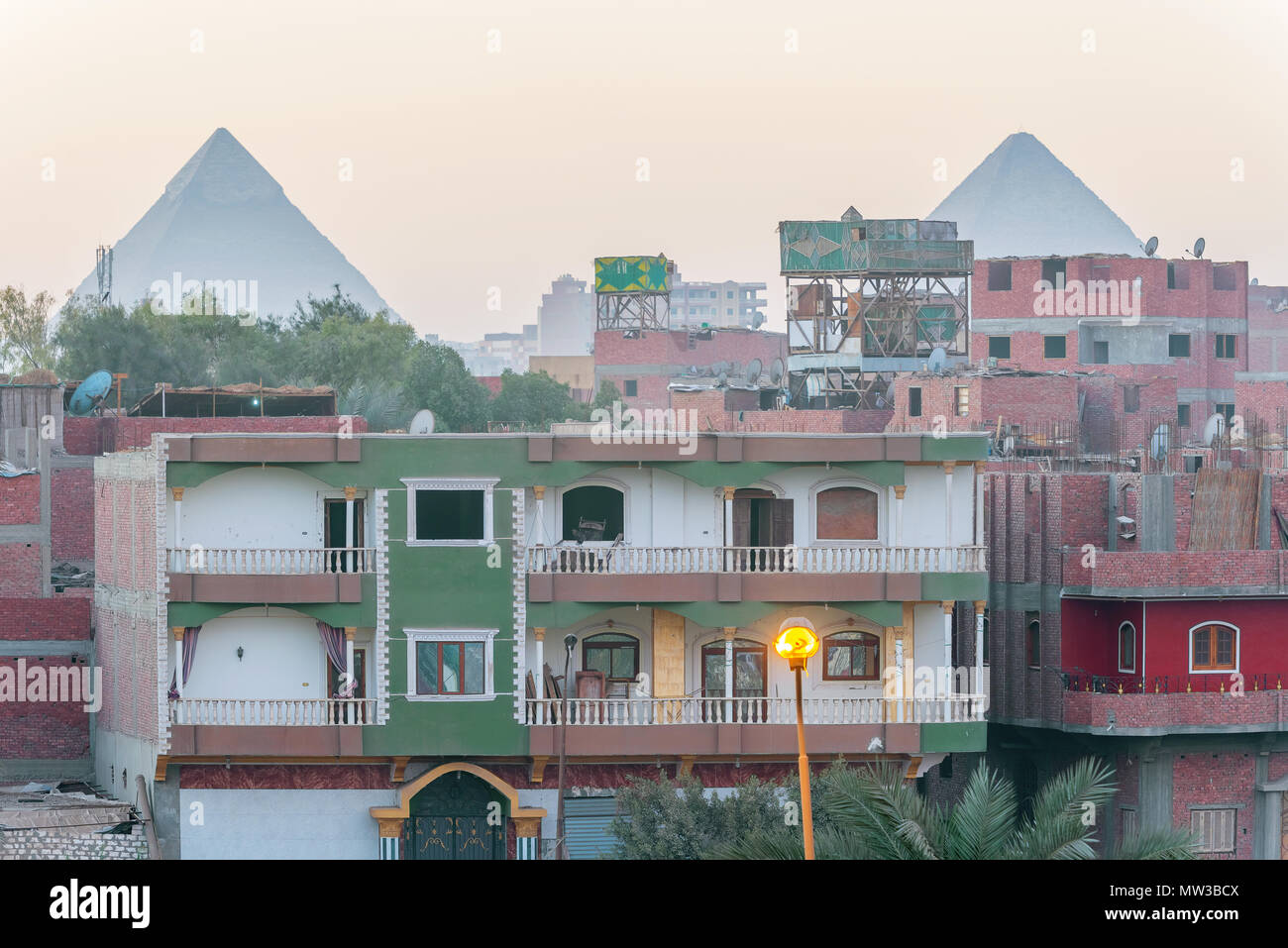 View at the apartment houses in Cairo and the Giza pyramids at the ...
