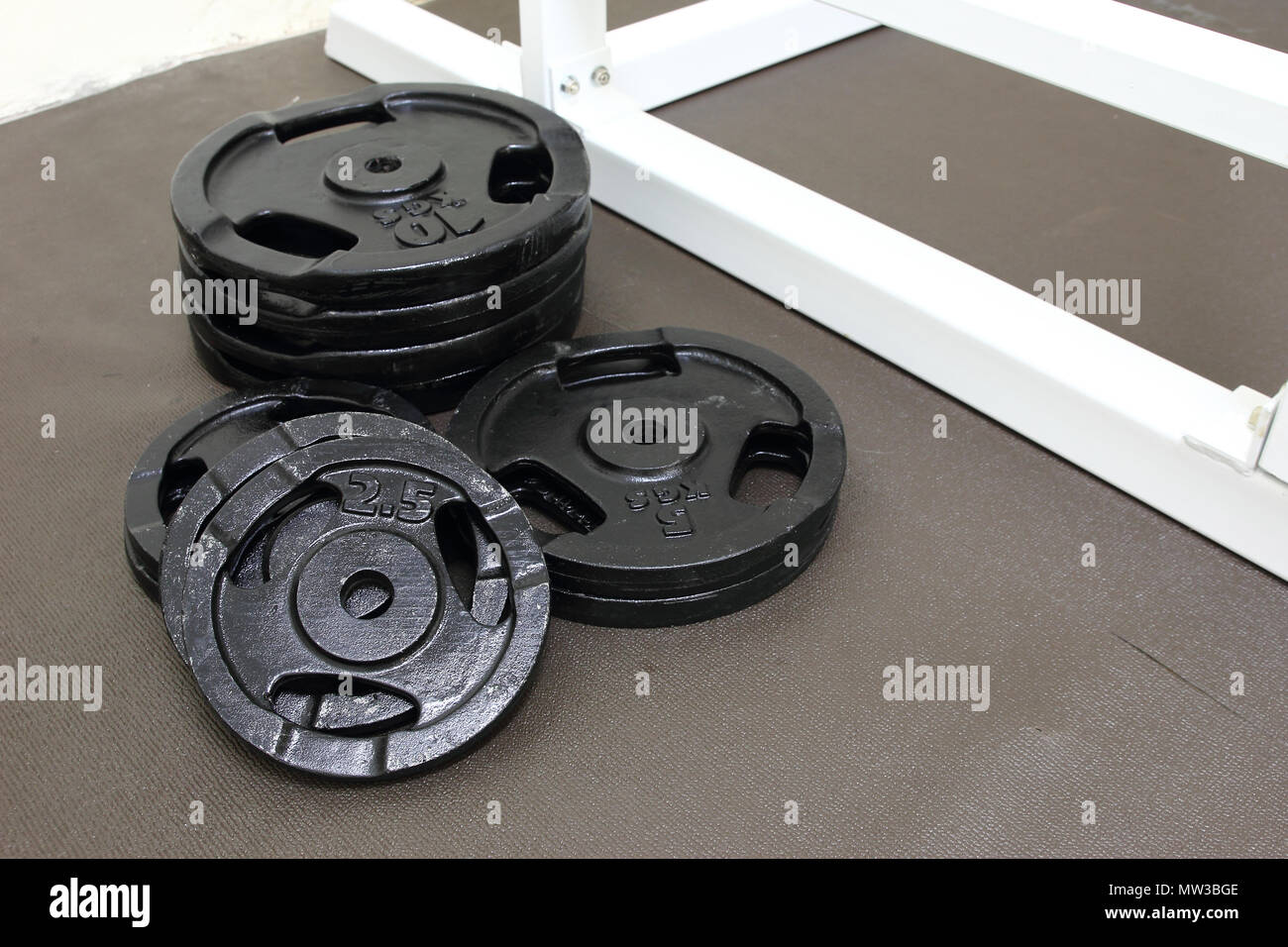 Barbells weight plate in gym room Stock Photo - Alamy