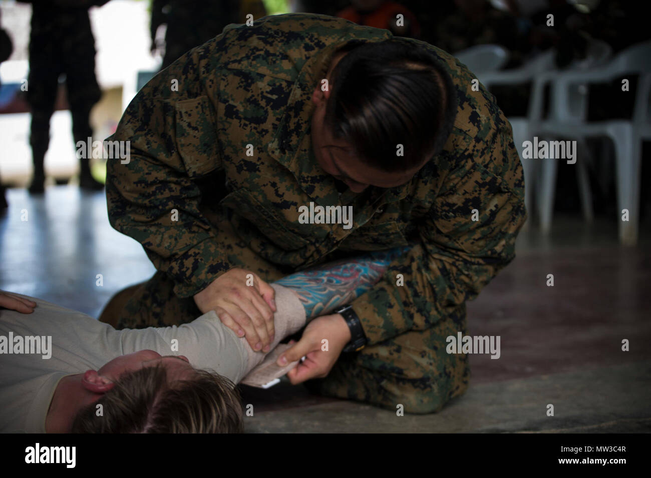 U.S. Navy Petty Officer 2nd Class Jared Gopiao demonstrates use of a ...
