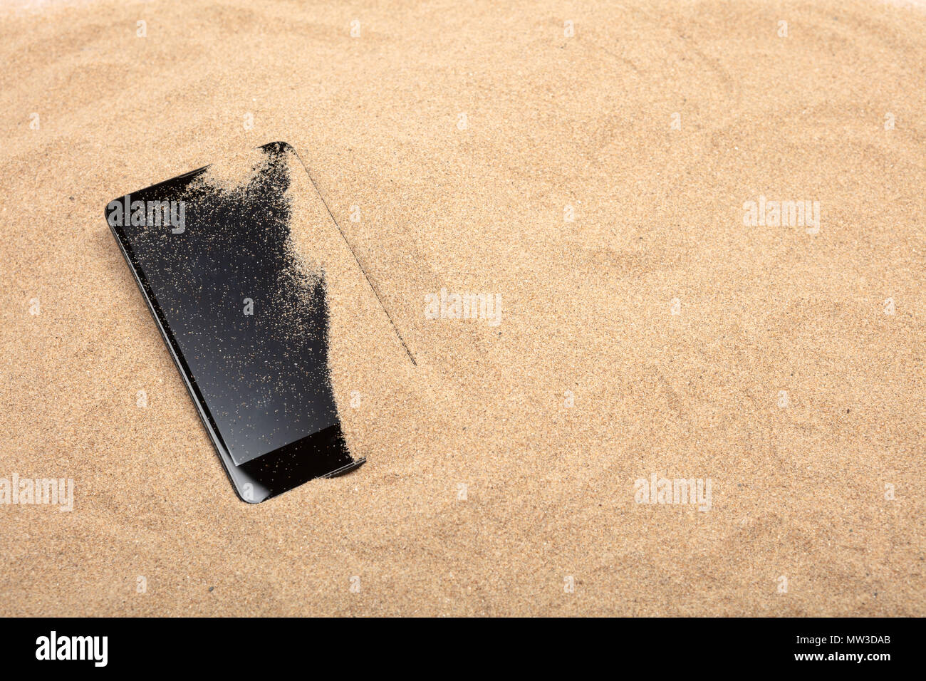 Close up smart phone on sand beach texture background. Copy space of ...