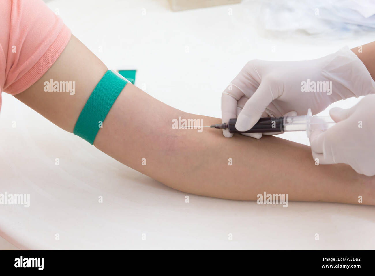 Laboratory with nurse taking blood sample from patient Stock Photo - Alamy