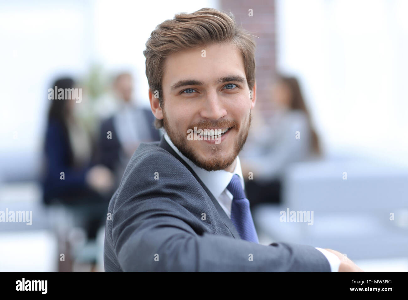 Successful business man standing with his staff in background at Stock ...