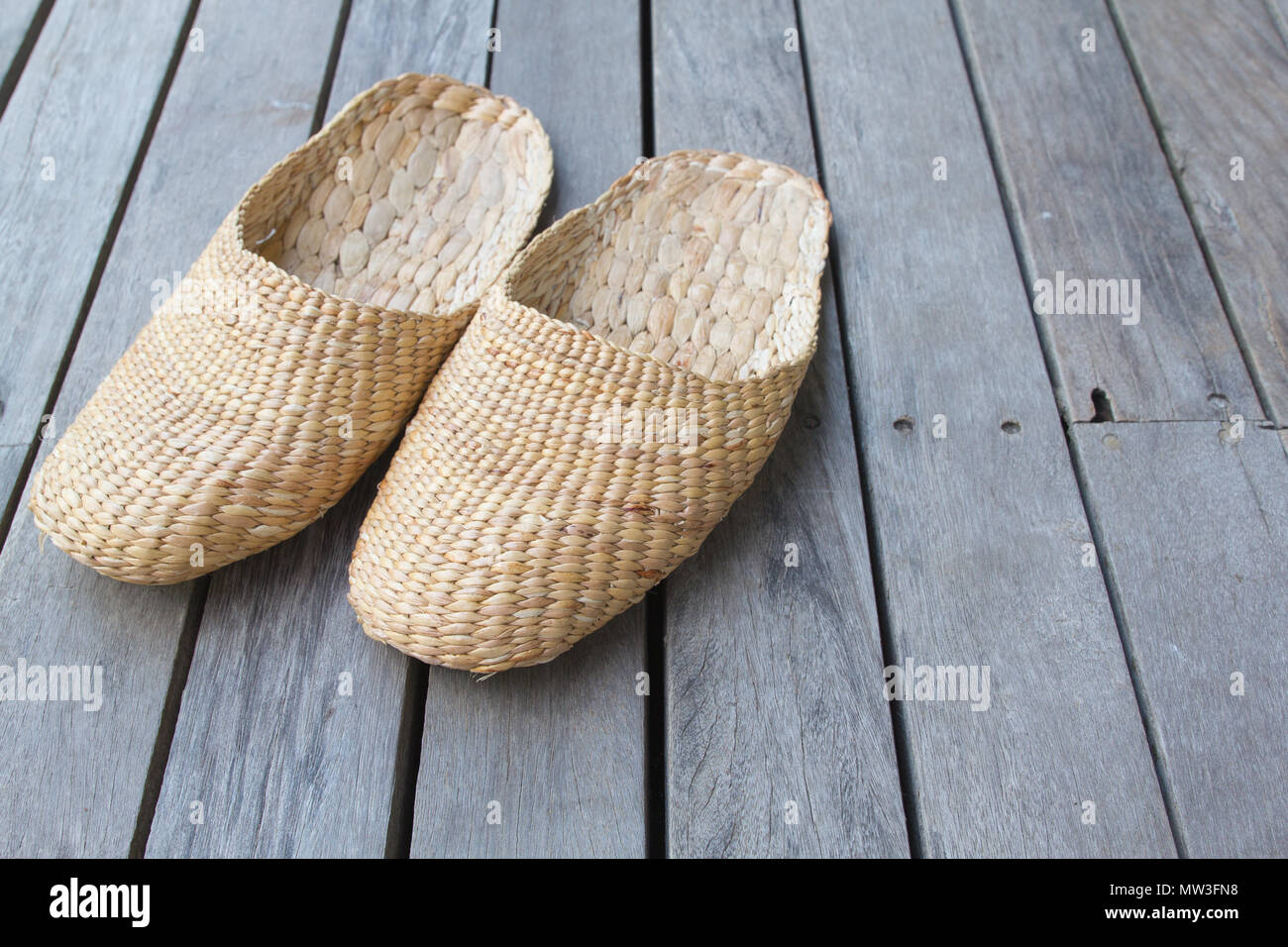 Vintage slippers handmade with bamboo on wood floor Stock Photo - Alamy