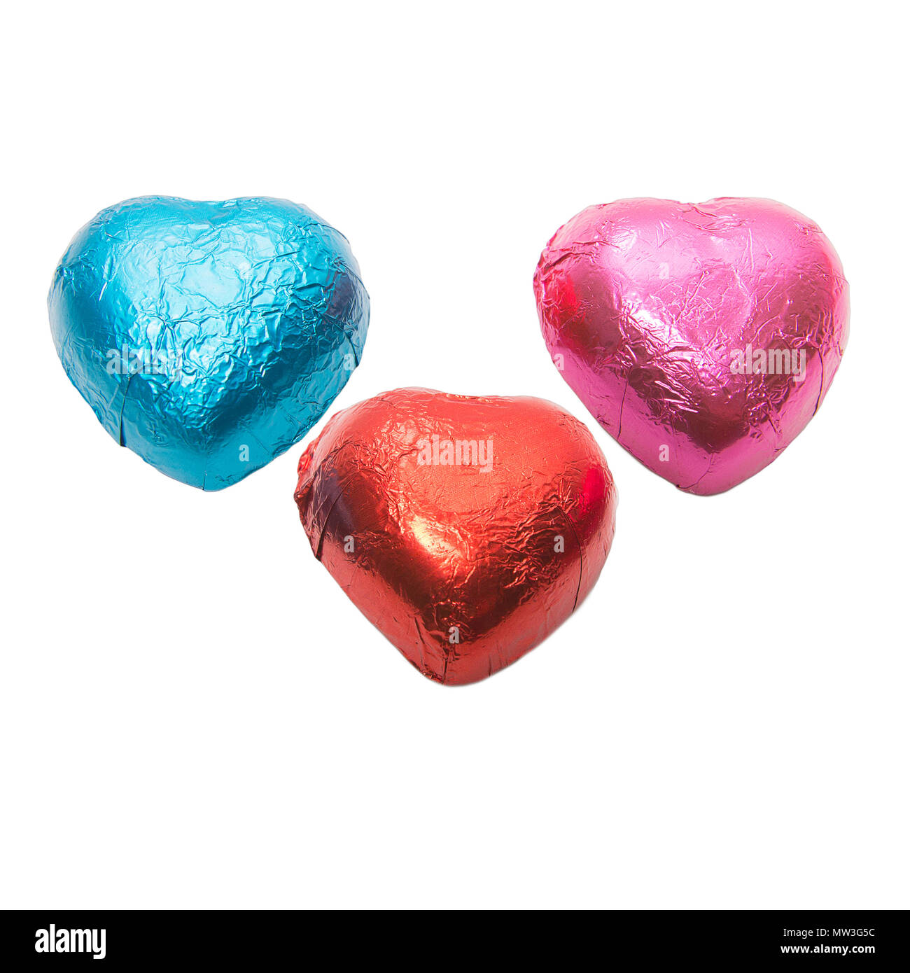 Three color chocolate hearts candy on white background Stock Photo - Alamy