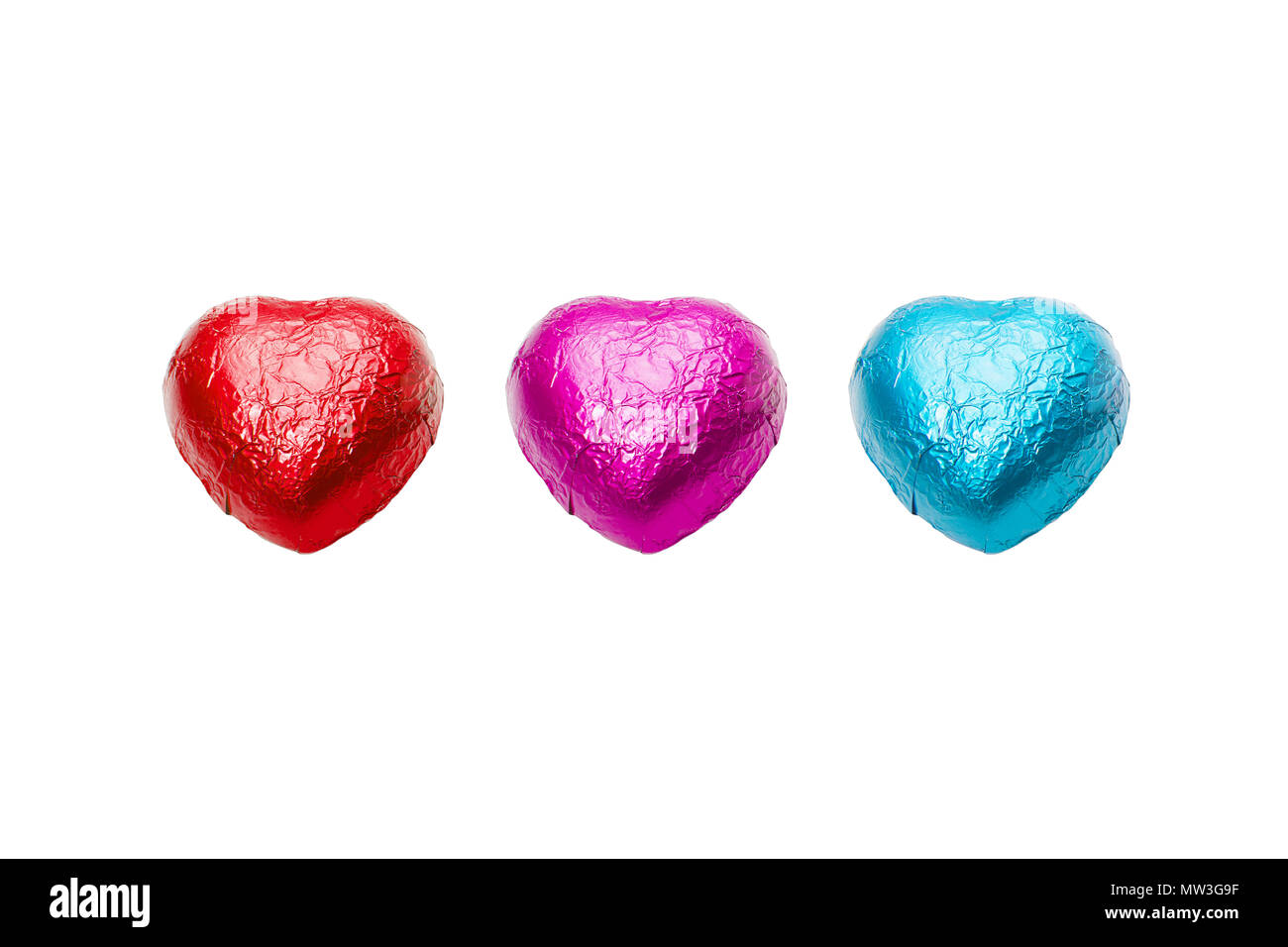 Three color chocolate hearts candy on white background Stock Photo - Alamy