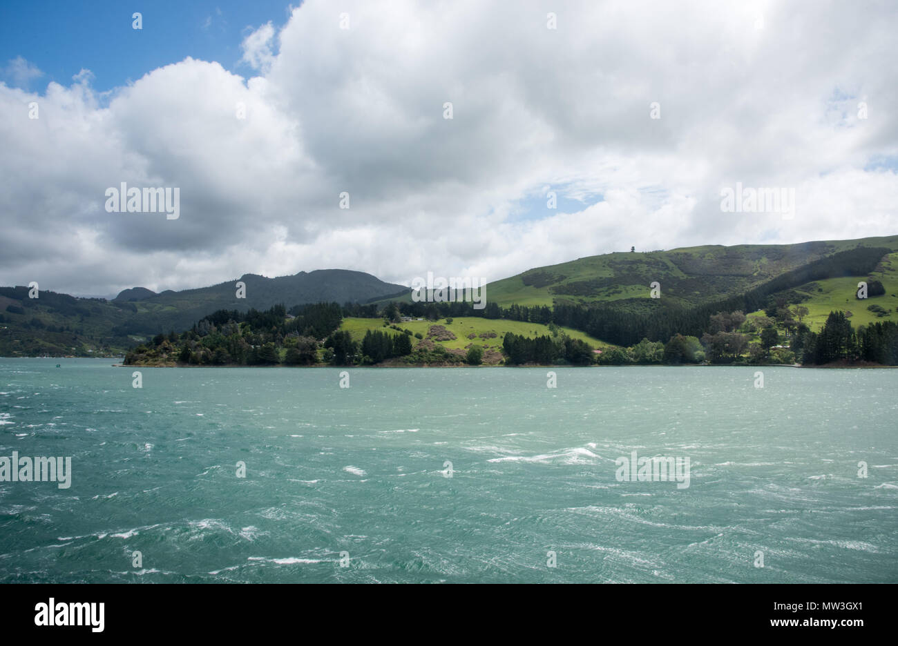 Turquoise seas and rolling, green landscape under a blue sky with ...