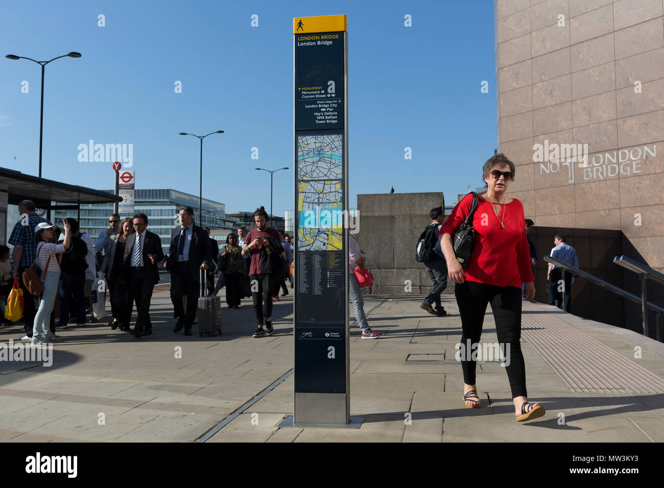 Commuters and other pedestrians walk over London Bridge, the oldest of ...
