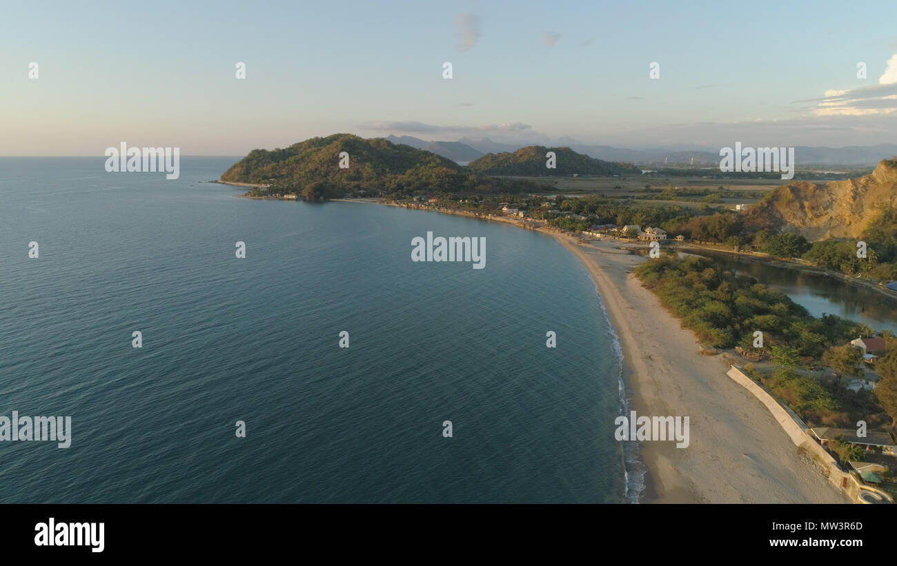 Aerial view of seashore with beach and mountains with sky and clouds at ...