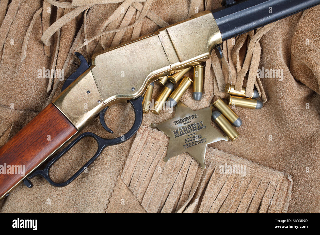 Wild west period repeating rifle with ammunition and sheriff badge ...