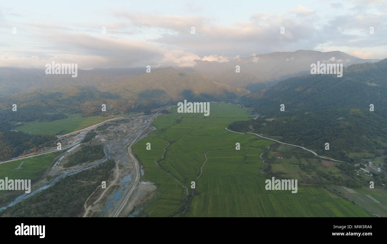 Aerial view of farmer fields, river, village in the background of ...