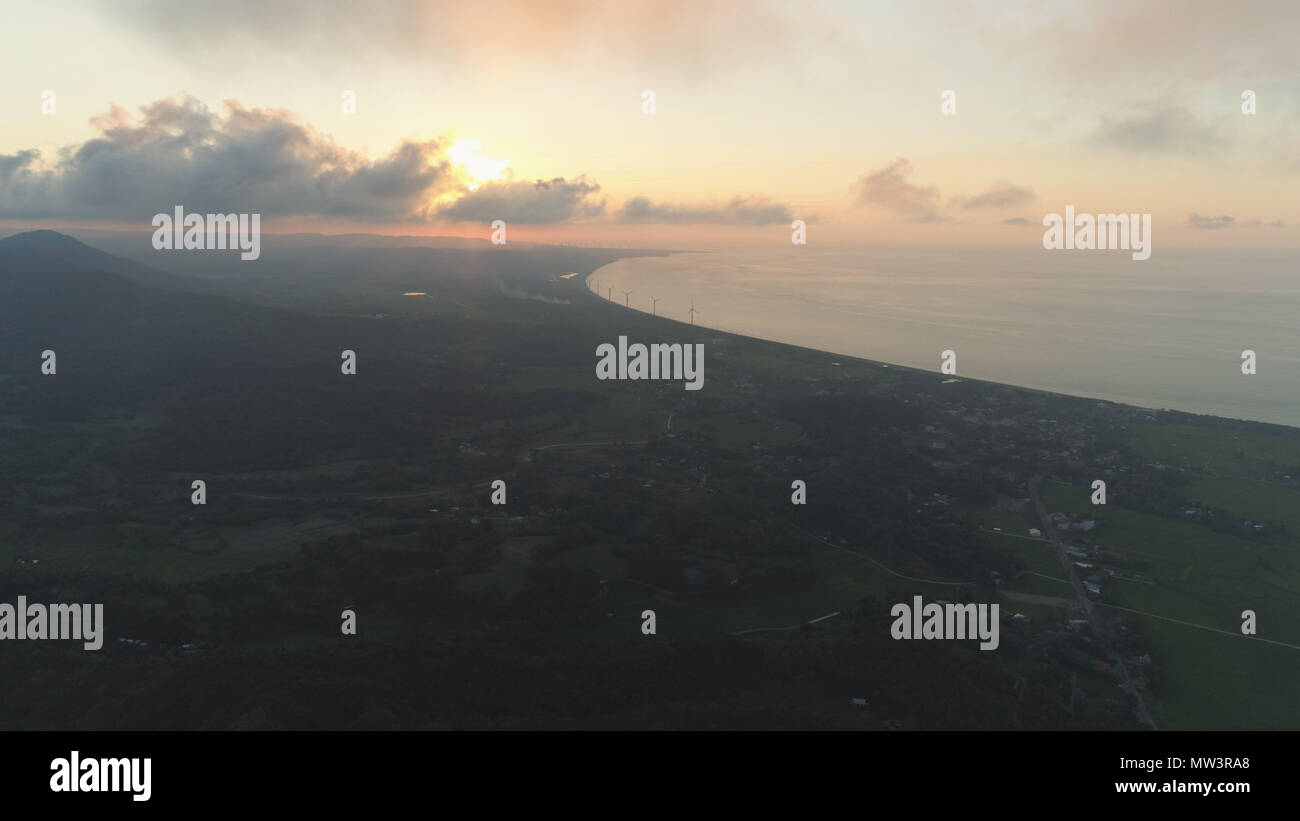 Aerial view of seashore with Windmills sky and clouds at sunset ...