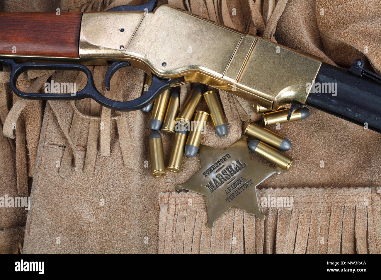 Wild west period repeating rifle with ammunition and sheriff badge ...