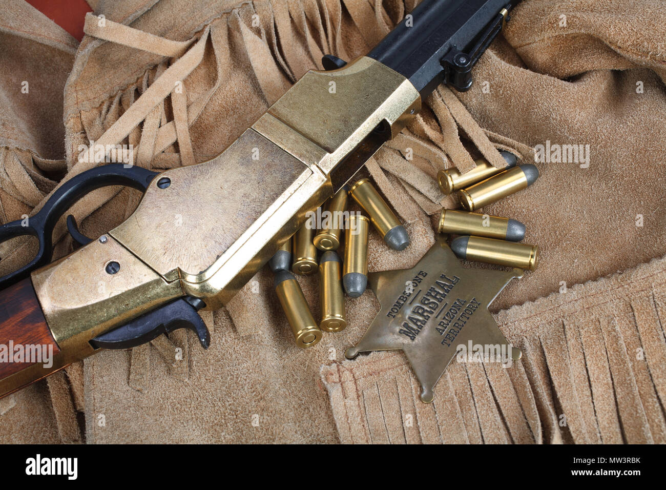 Wild west period repeating rifle with ammunition and sheriff badge ...