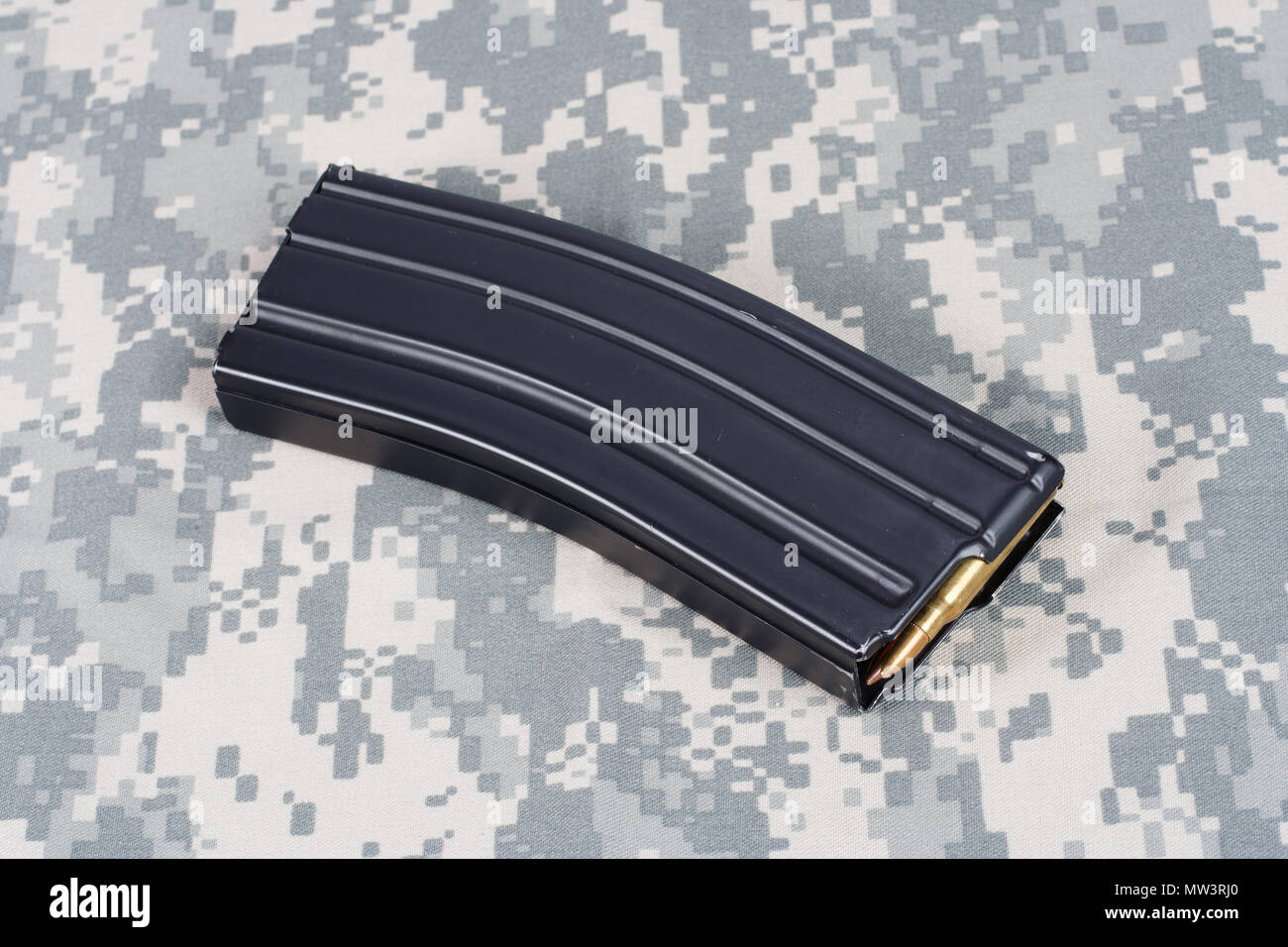 M16 rifle magazine with cartridges on camouflage uniform background ...