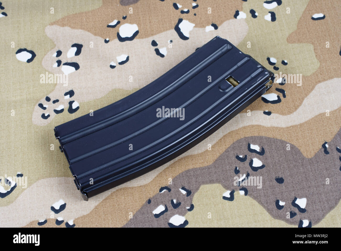 M16 rifle magazine with cartridges on camouflage uniform background ...