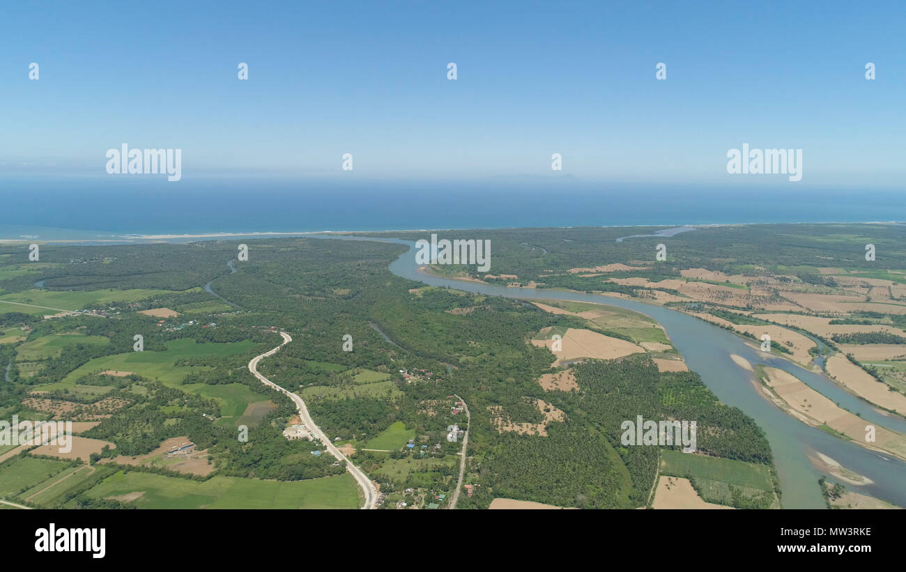 River passing through farmlands and flowing into sea. Philippines ...