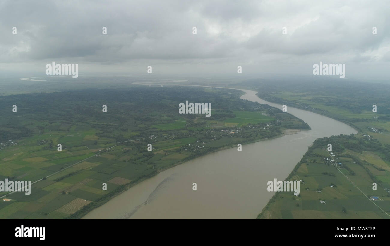 River passing through farmlands and rice terraces. Philippines, Luzon ...