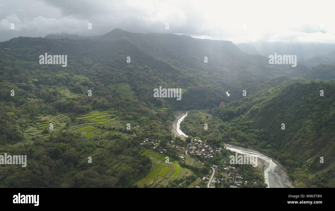 Aerial view of mountain valley with river, rice terraces, farmland in ...
