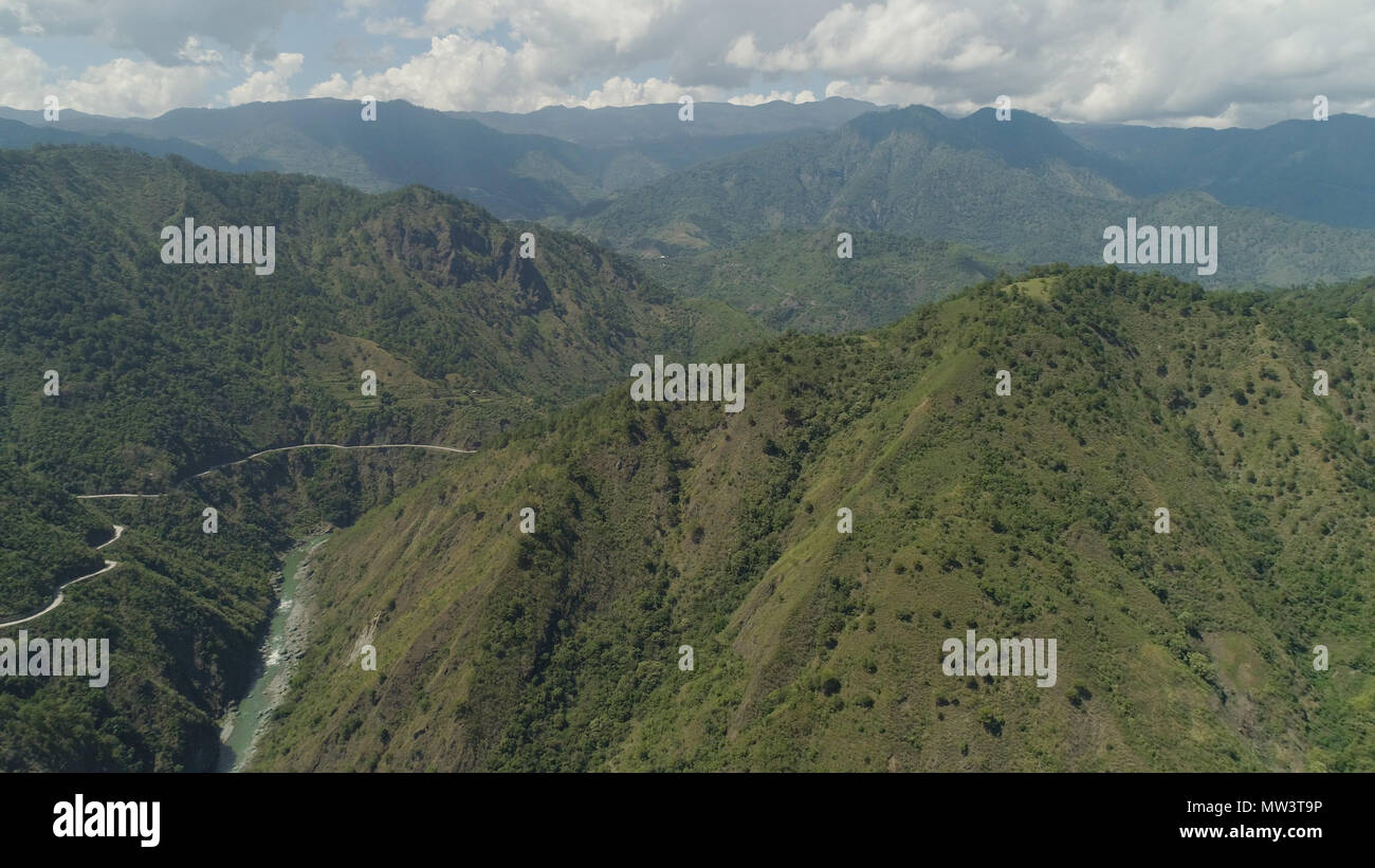 Aerial view of mountain river in the cordillera, road on the slopes ...