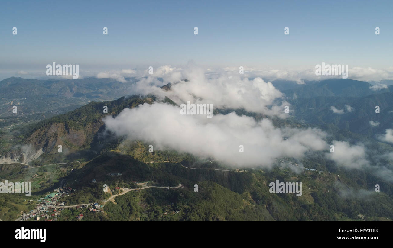 Aerial view of mountains covered forest, trees in clouds. Cordillera ...