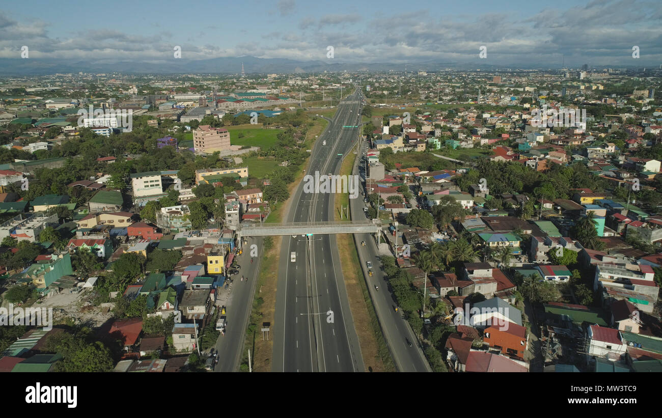 Aerial view of highway with road junction, car and traffic in Manila ...