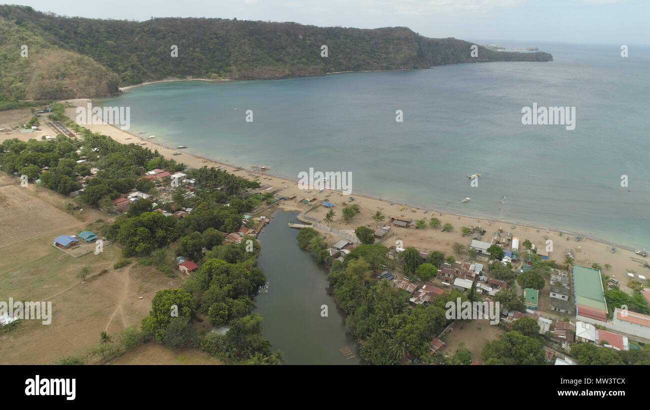 Aerial view of coast with beach in blue lagoon. Philippines, Luzon ...