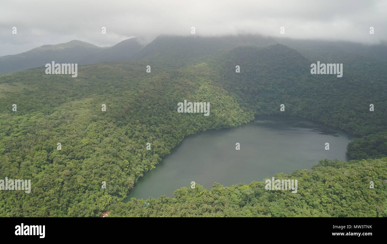 Aerial view of lake Bulusan in the mountains with green rain forest ...