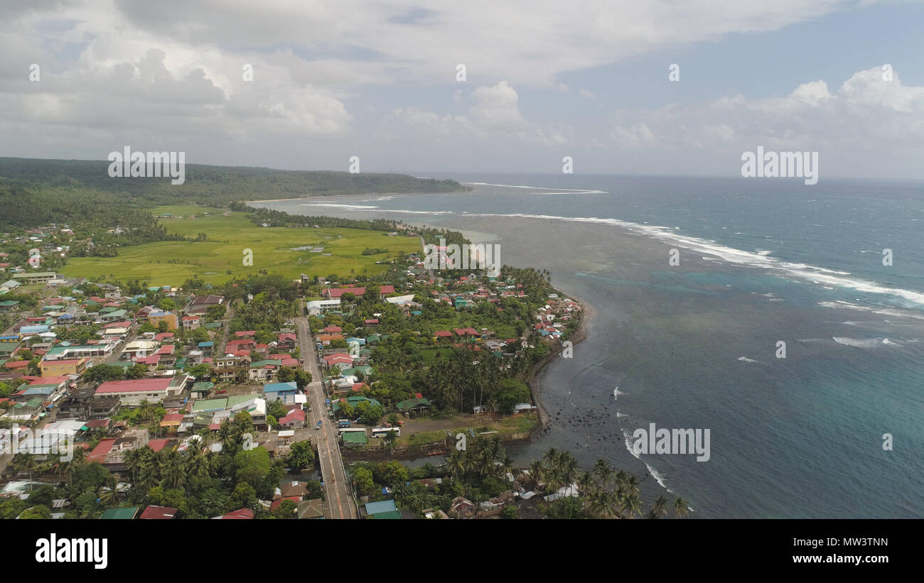 Aerial view of seashore with coastal town, beach, lagoons and coral ...