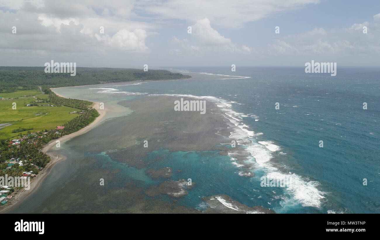 Aerial view of seashore with coastal town, beach, lagoons and coral ...