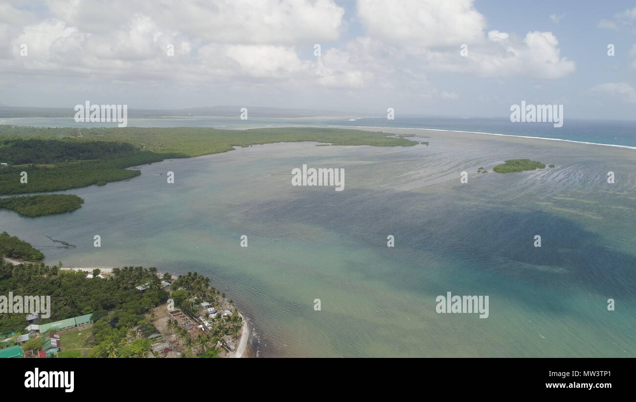 Aerial view of seashore with coastal town, beach, lagoons and coral ...