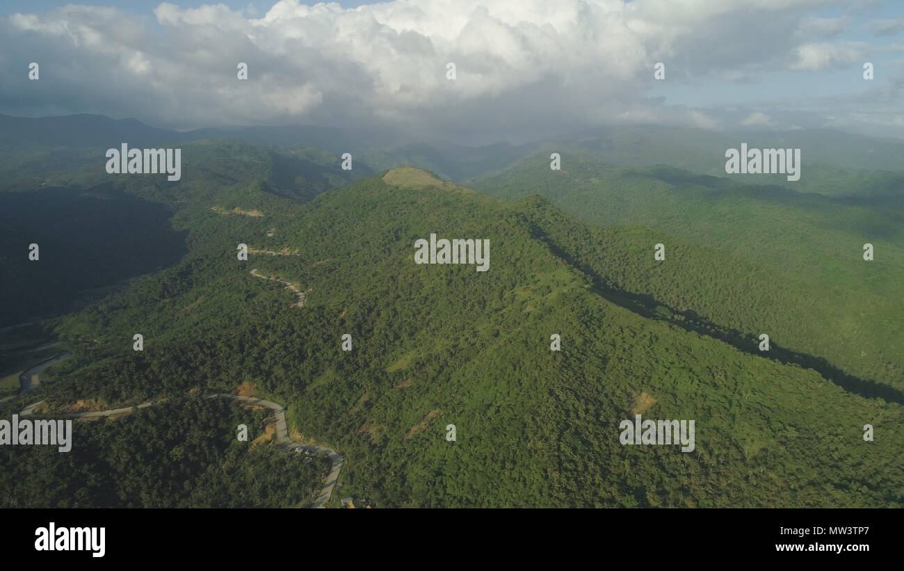 Aerial view of mountains covered rain forest, trees with clouds and sky ...
