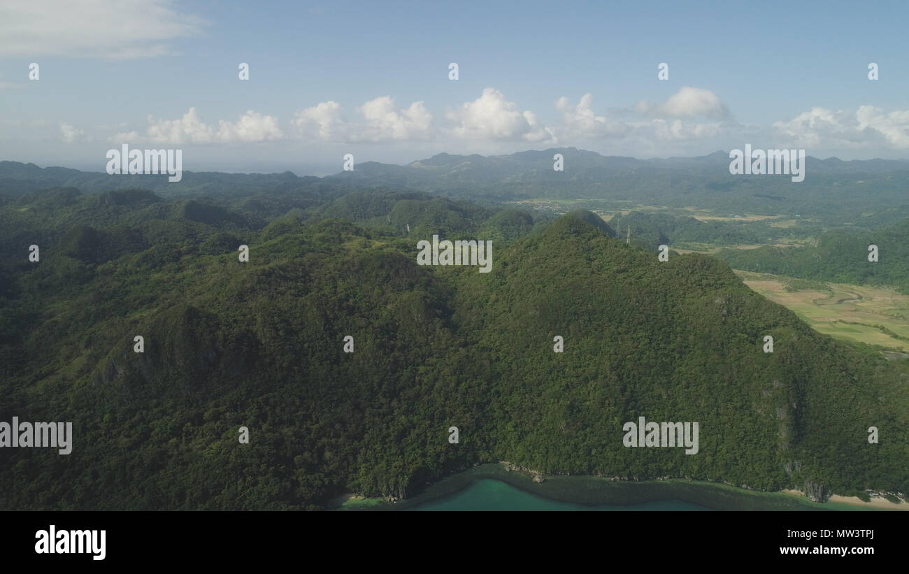 Aerial view of mountains covered rain forest, trees with clouds and sky ...
