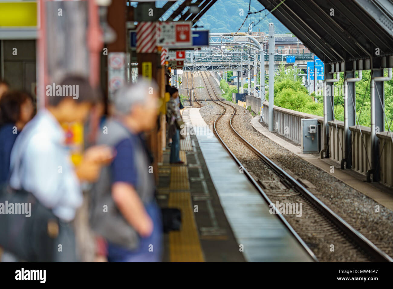 Blurred people waiting for train Stock Photo - Alamy