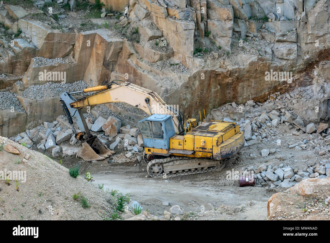 Mining in the granite quarry. Working mining machine - old digger ...