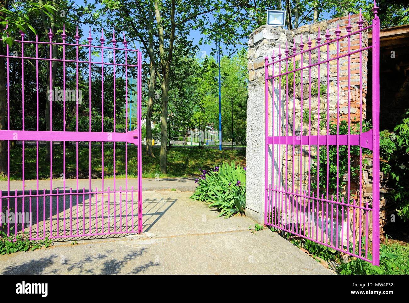 Entrance with pink gate Stock Photo - Alamy