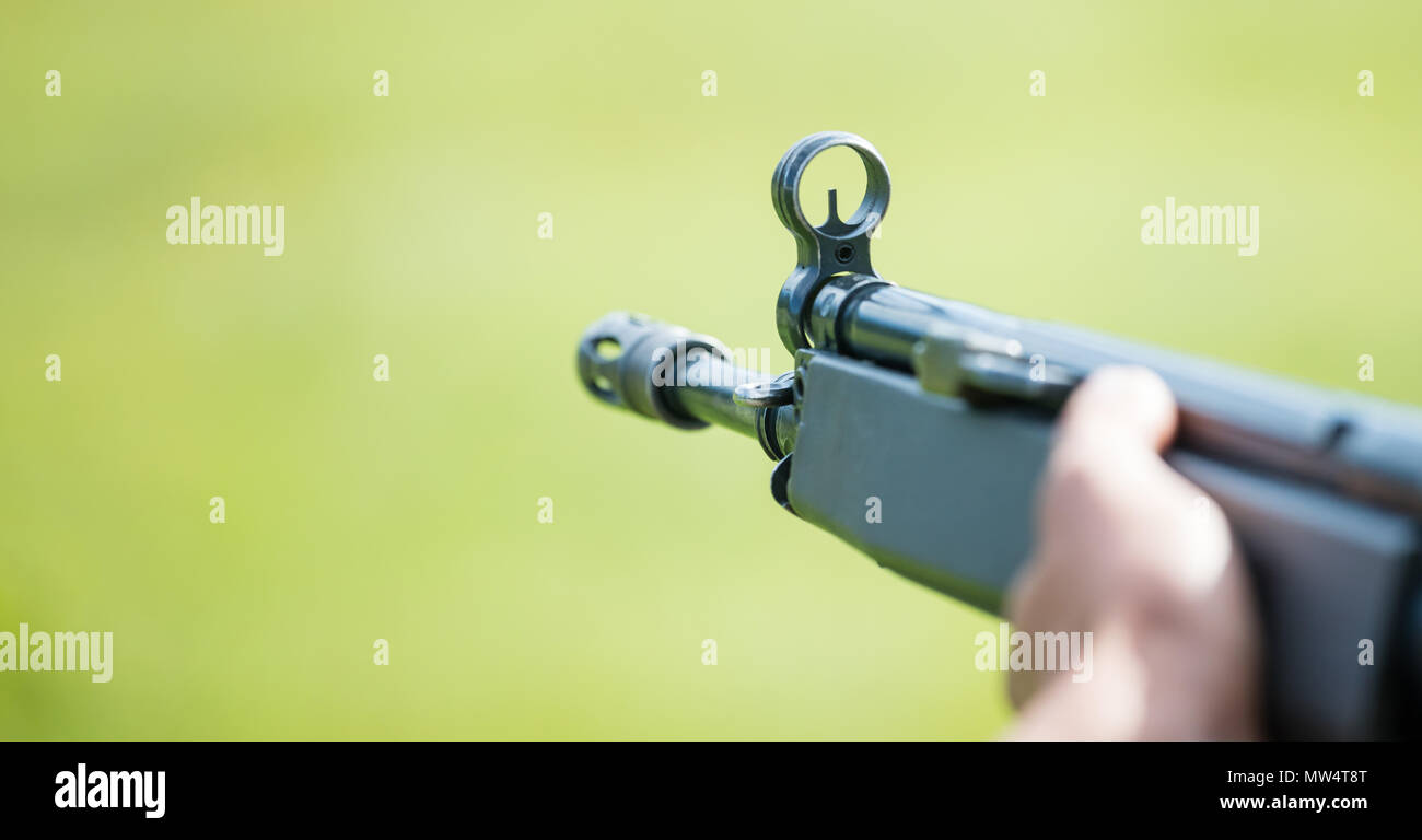 Firearm handgun in man' s hand who marks the target. Front side of ...